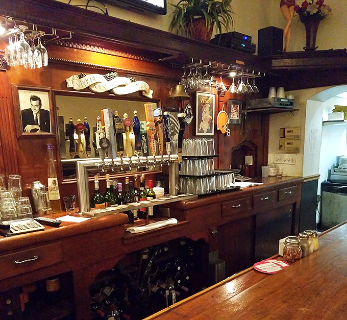 The bar area gleams with promise &ndash; wine glasses hanging like crystal stalactites above a wooden counter polished by decades of elbows.