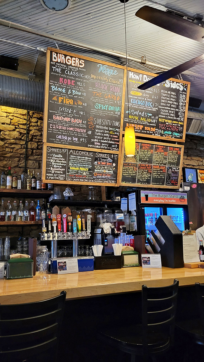 The chalkboard menu wall feels like reading a love letter to burger possibilities, written in multicolored chalk and pure passion.