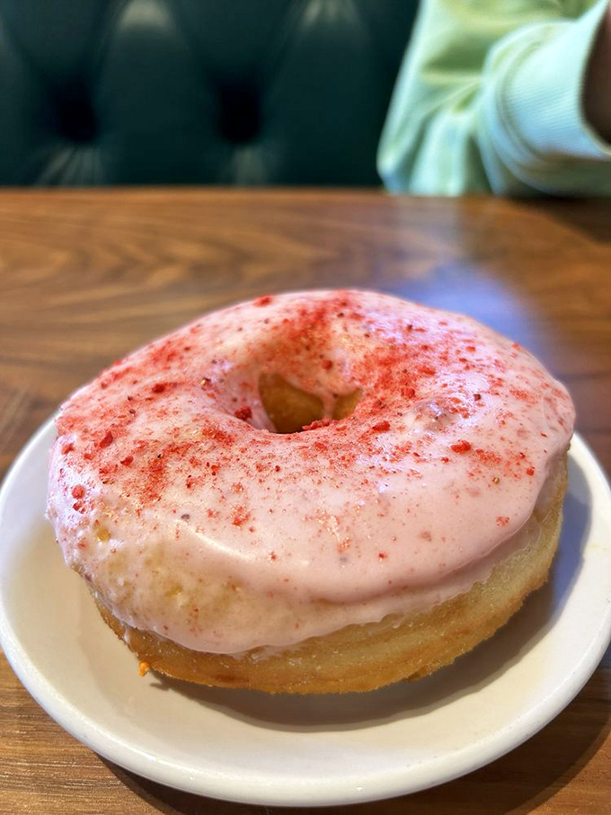 This donut isn't just breakfast&mdash;it's a mood-altering experience. The strawberry glaze sparkles like morning sunshine after a perfect night's sleep.
