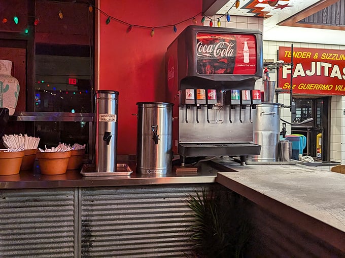 The beverage station stands ready for thirsty patrons. That vintage Coca-Cola machine has probably witnessed thousands of salsa-induced "water emergencies."