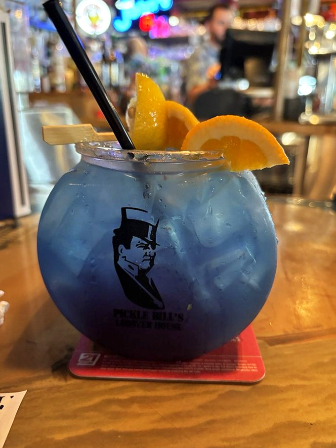 This blue lagoon cocktail isn't just a drink&mdash;it's a vacation in a glass with Pickle Bill himself keeping watch.