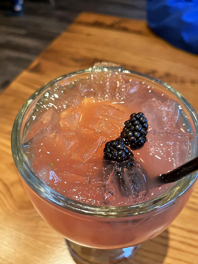 A cocktail that's dressed better than most people at the restaurant. Those blackberries aren't just garnish&mdash;they're little flavor bombs waiting to explode.