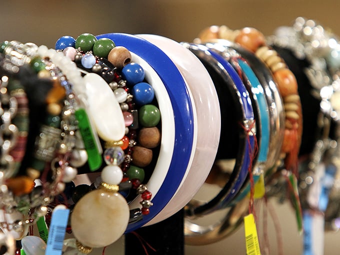 A rainbow of bracelets awaits new wrists to adorn. Jewelry shopping becomes a treasure hunt when each piece has its own mysterious history.