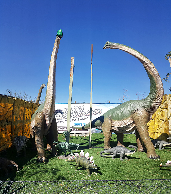 Long-necked giants reach for the sky while their smaller cousins gather below, creating a multi-level prehistoric family reunion.