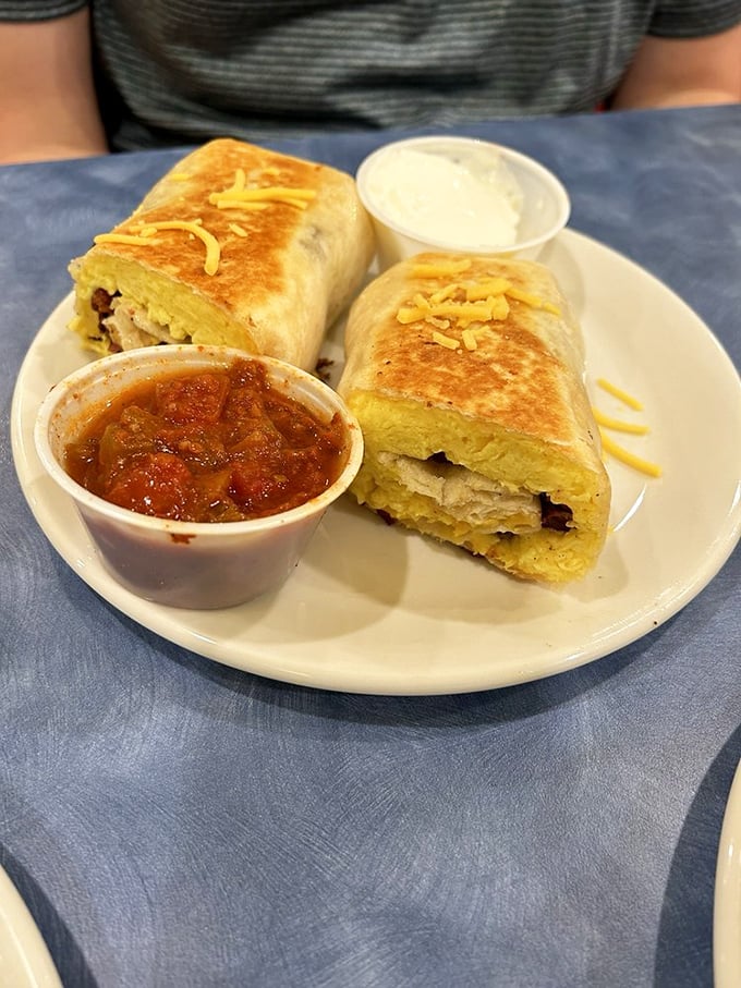 Breakfast burritos: proof that good things come in tortilla packages. Melted cheese peeks out like it's trying to make new friends.
