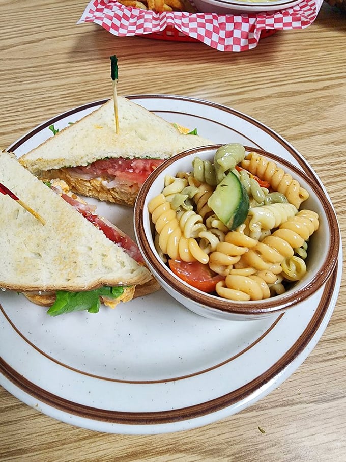 A sandwich that requires strategy to eat. Pasta salad on the side offers a refreshing counterpoint to the main event's savory richness.