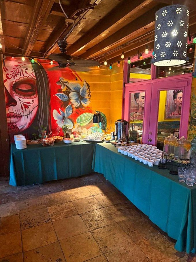 Day of the Dead comes alive! This vibrant buffet setup with its colorful mural backdrop transforms ordinary catering into a cultural celebration.