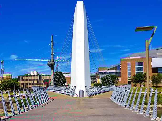 The Center Street Bridge's gleaming white arch stands like a modern exclamation point against Des Moines' blue skies.
