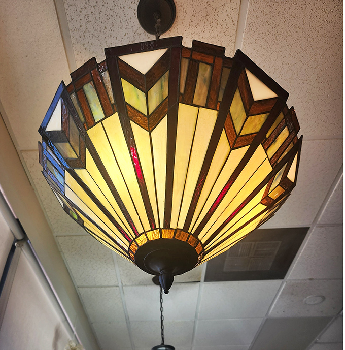 Stained glass chandeliers cast a warm glow throughout the restaurant, adding unexpected charm to this unpretentious eatery.