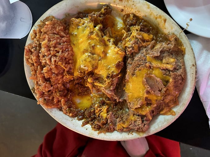 These enchiladas don't just get covered in cheese&mdash;they practically disappear beneath it, creating that beautiful Tex-Mex magic where everything melts together in perfect harmony.