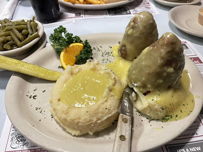Chicken croquettes standing proud in a pool of gravy like delicious islands of comfort. That mashed potato crater is engineering designed for maximum sauce capacity. 