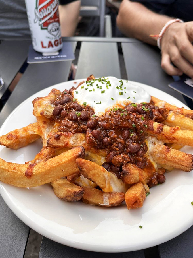 Chili cheese fries that demand to be shared but inspire selfishness. That perfectly runny egg on top is the crown jewel of this comfort food kingdom.