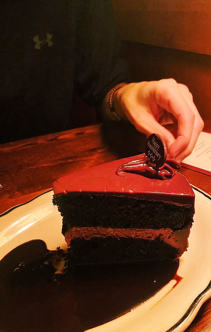 Chocolate cake so intense it requires a moment of silence. Three layers of cocoa commitment with a glossy ganache seal.