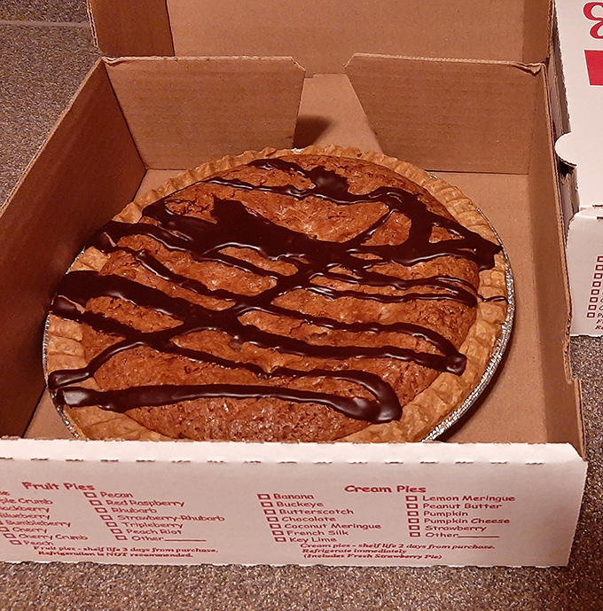 A cookie pie with artistic drizzle that proves sometimes the best innovations come from traditional bakeries, not trendy food labs.