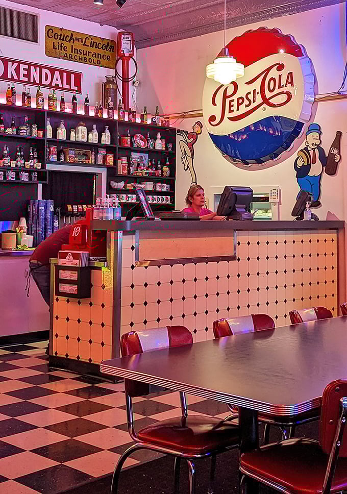 Behind this Pepsi-themed command center, culinary magic happens. The black and white floor isn't just decorative&mdash;it's a chess board where flavor always wins.
