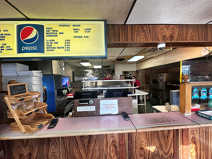The counter where pizza dreams come true, complete with chip racks that haven't changed their layout since the Clinton administration.