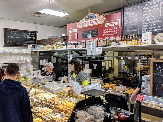 Behind the counter, where donut dreams come true. The staff works with the precision of Swiss watchmakers and the warmth of your favorite aunt. P