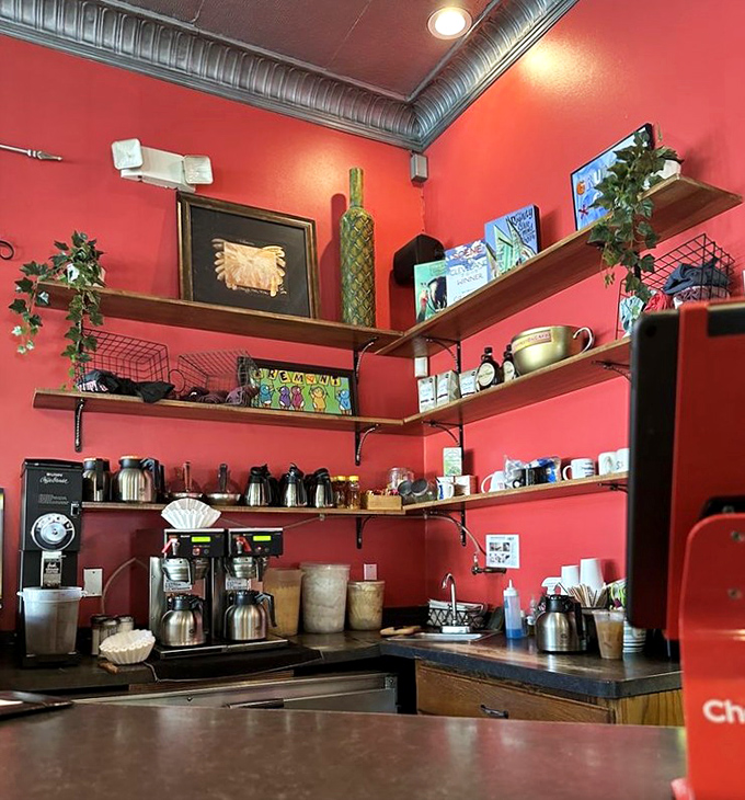 Behind these shelves and coffee machines lies the secret to starting your day right. The red walls practically radiate morning energy.