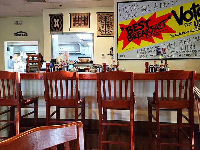 Counter seating: where solo diners become breakfast philosophers and the "Best Breakfast" sign speaks nothing but truth.