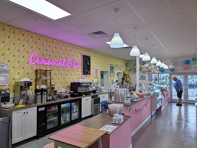 Pink neon against yellow walls &ndash; it's not just a bakery, it's a mood. The counter where croissant dreams come true.