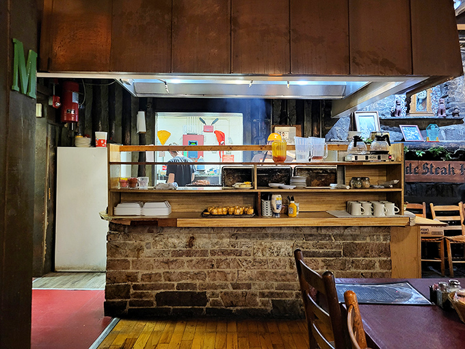 Behind this rustic counter, culinary magic happens with the kind of no-nonsense efficiency that makes you trust the food before it even arrives.