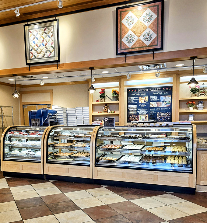 The bakery display case&mdash;where willpower goes to die and happiness begins. Those quilts overhead remind you this is authentic Amish Country.