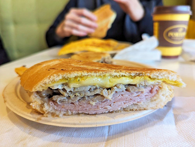 The Cuban sandwich, sliced to reveal its perfect stratification of meats and cheese&mdash;a cross-section of happiness between two pieces of bread.