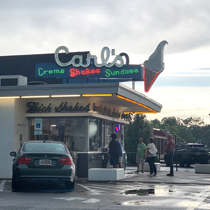 The neon glow of Carl's at dusk transforms an ice cream stop into something more profound&mdash;a pilgrimage to a temple of frozen delight.