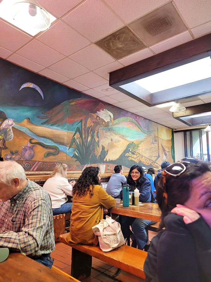 The colorful mural provides a backdrop for the diverse crowd. From tech workers to tourists, great food is the universal language spoken here.