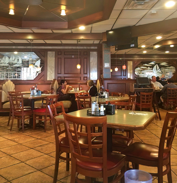 The dining room hums with conversation and silverware clinks &ndash; the soundtrack of contentment playing beneath pendant lights and waterfowl etchings. 