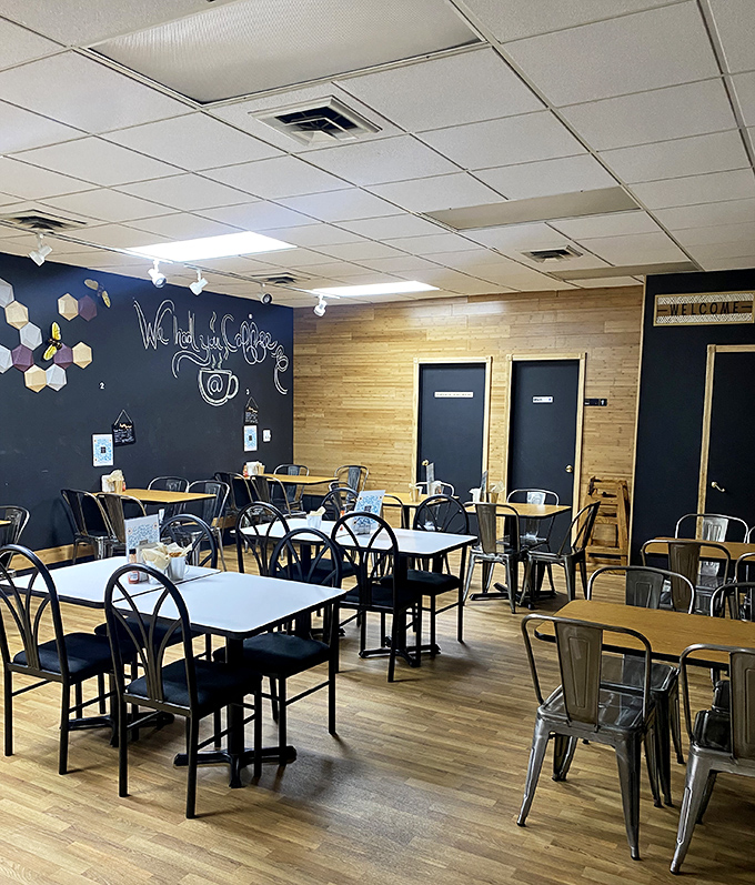 Simple metal chairs, wooden tables, and a chalkboard wall create the perfect backdrop for culinary creativity without unnecessary fuss.