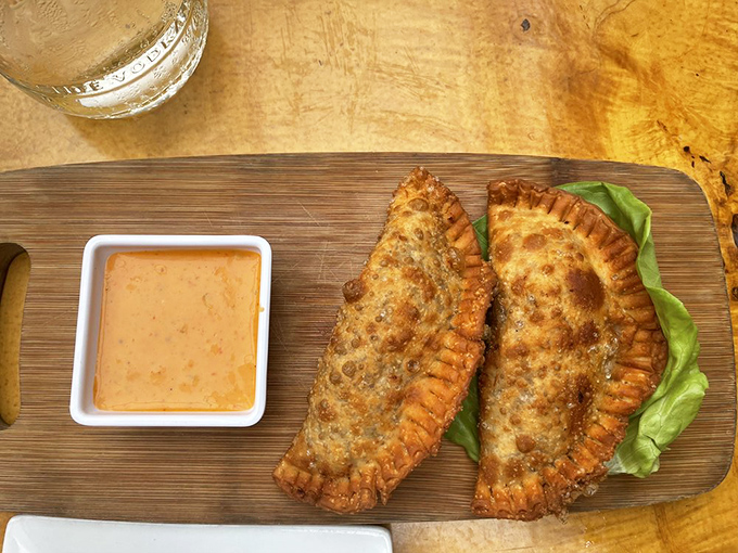 Empanadas: the perfect hand-held happiness delivery system. Crispy exterior gives way to a flavorful filling that makes you wonder why you'd eat anything else.