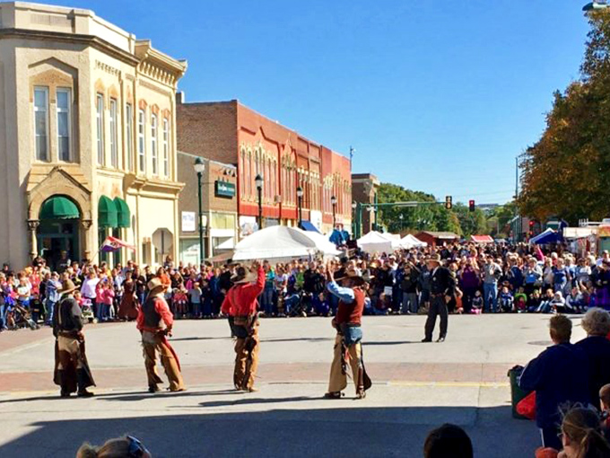 The Covered Bridge Festival transforms Winterset's streets into a celebration where performers tip their hats to the town's Western heritage.