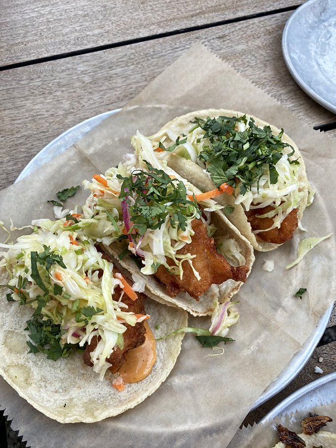 Fish tacos done right: crispy battered cod, fresh slaw, and a splash of lime. The ocean meets the corn field in this perfect Michigan-Mexican fusion.