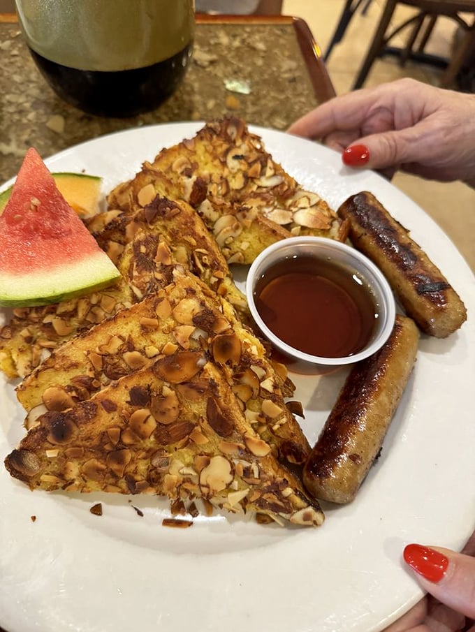 French toast wearing a coat of toasted almonds, looking so good it makes maple syrup nervous about living up to the occasion.