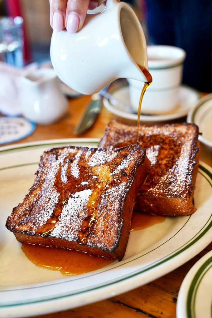 French toast that's had a spa treatment in custard before being caramelized to perfection. That maple syrup pour is food cinematography at its finest.