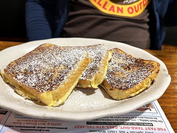 French toast that's crossed the line from breakfast to dessert &ndash; powdered sugar, golden exterior, and a custard-like center that defies gravity.