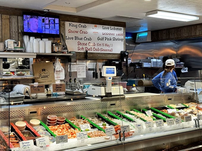 The fish market display case&mdash;where the day's catch waits patiently to become tonight's dinner story, with helpful staff to guide your selection.