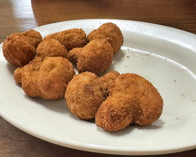 Fried mushrooms that achieve the impossible: crispy exteriors giving way to juicy centers. These little flavor bombs deserve their own fan club.