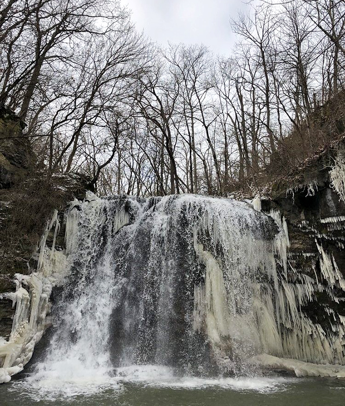 Winter's artistic touch creates ice sculptures alongside flowing water. Like nature decided to freeze time itself along the edges of the falls.