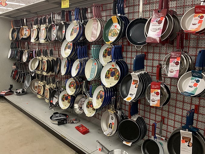 Kitchen dreams materialize in the cookware section, where professional-looking pans hang like trophies waiting to transform home chefs.