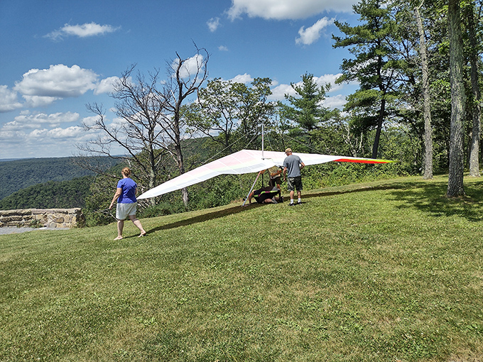 Humans borrowing wings. These hang gliding enthusiasts prepare for that heart-stopping moment when gravity temporarily loosens its grip.