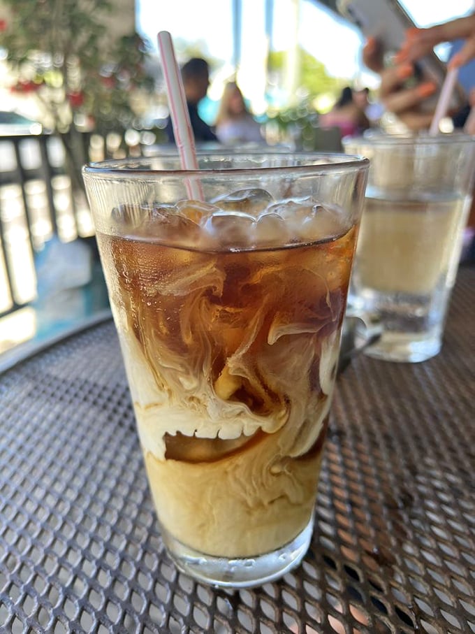 Iced coffee swirling with cream like a caffeinated work of art. The kind of morning companion that makes Monday feel like Saturday.