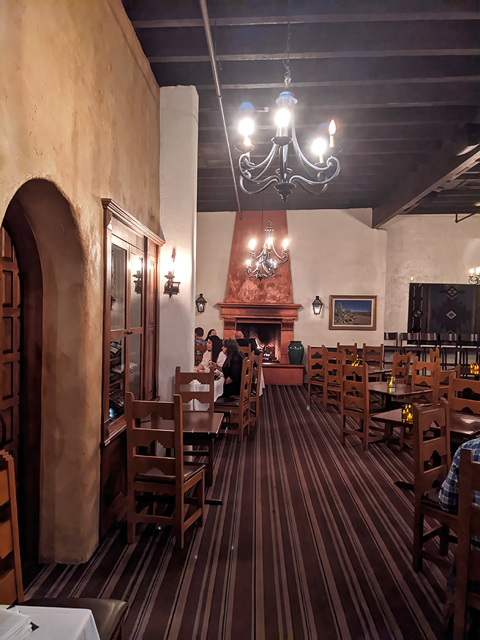 Pull up a chair and step back in time&mdash;this cozy dining room feels like a warm hug from an old adobe inn, complete with flickering sconces and a fireplace ready for stories.