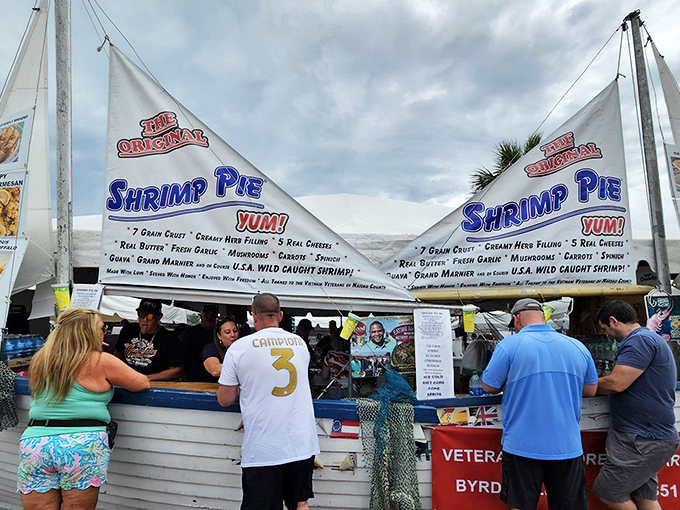 The Shrimp Pie stand at the annual festival proves that seafood innovation is alive and well. When a food item needs sails to advertise itself, you know it's something special.