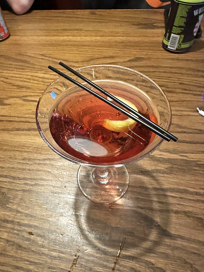 This cocktail isn't just mixed; it's carefully composed, like the ruby-hued finale of a symphony dedicated to your taste buds.