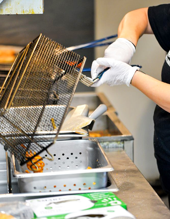 Behind every perfect french fry is a skilled hand and a bubbling fryer. The kitchen ballet that transforms potatoes into golden happiness.