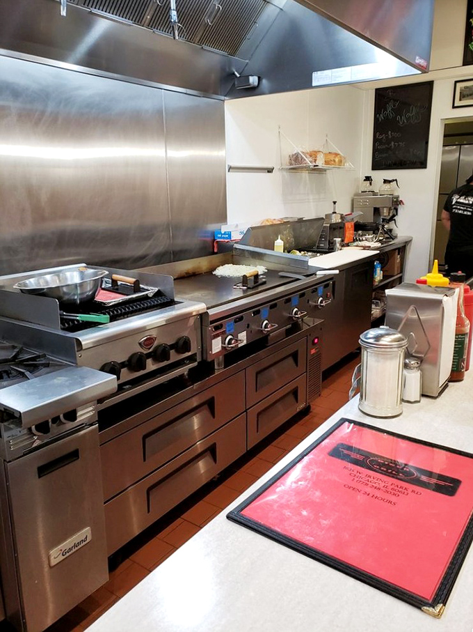The kitchen at Diner Grill&mdash;a symphony of stainless steel where breakfast dreams come true. No fancy gadgets, just well-seasoned equipment that knows its job.