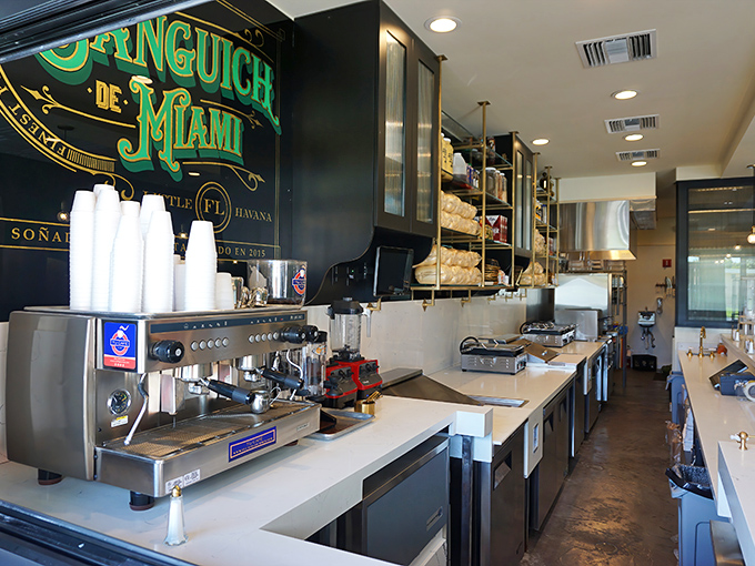 The "Sanguich de Miami" sign glows like a beacon of hope for the hungry. This is sandwich craftsmanship elevated to art.