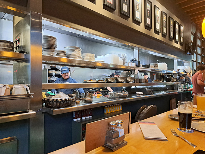 A glimpse into the engine room of flavor. The open kitchen design lets you witness the choreography that brings your meal to life.